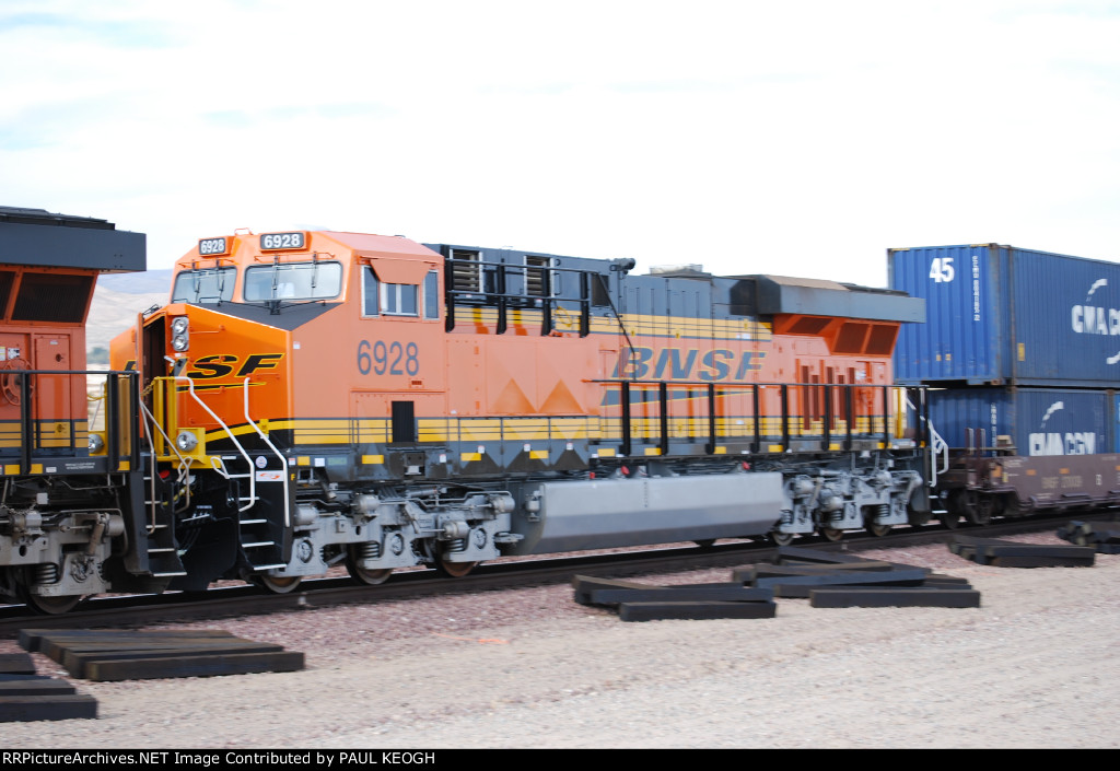 A Very, Very Brand New ES44C4 rolls past me as BNSF 6928 Heads eastbound as a lead Rear DPU on a ...